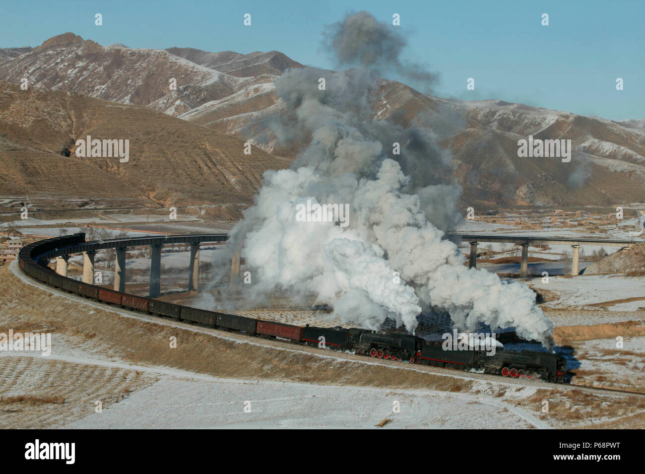 Two ex China Railway QJ Class 2-10-2s cross the famous curved viaduct ...