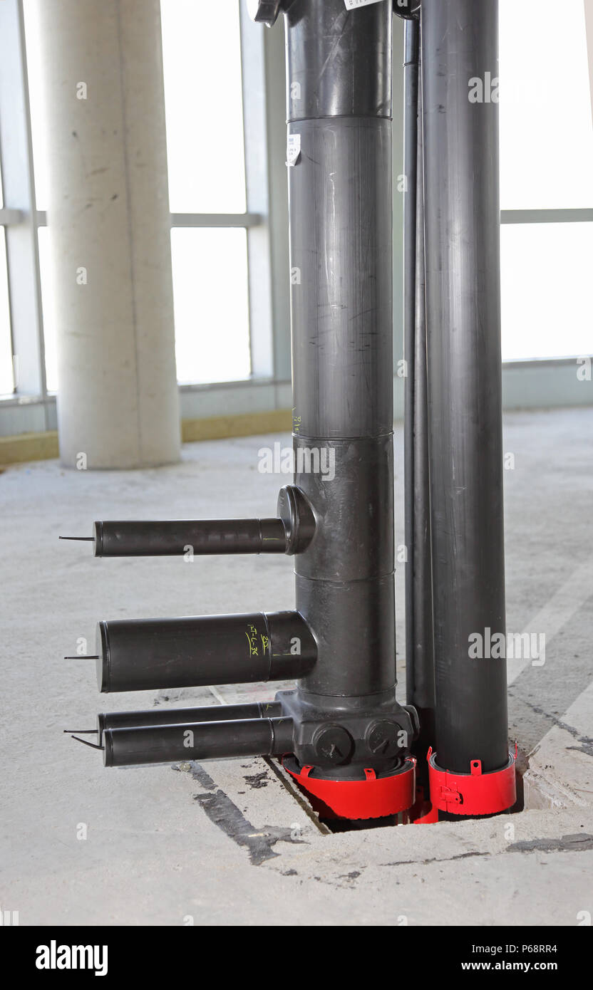 Plastic soil and waste pipes being installed in a new tower block in ...