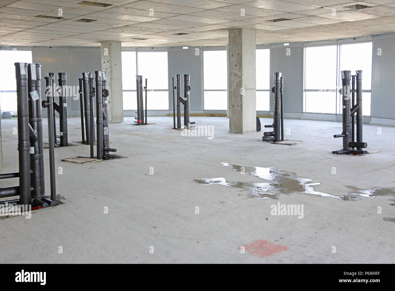 Plastic soil and waste pipes partially installed in a new apartment ...