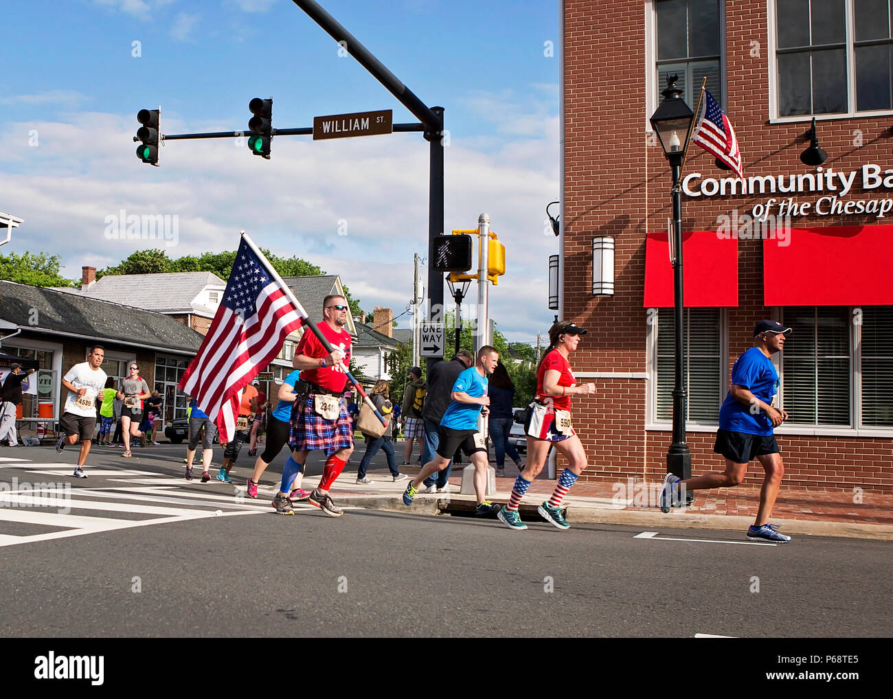 Runner James Marr carries the American flag during the 9th Annual ...