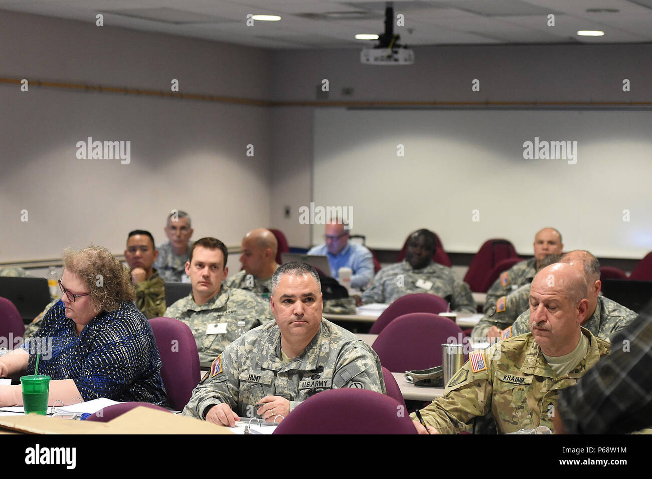 Class attendees finalize an exam, after a two-day course, ensuring that ...