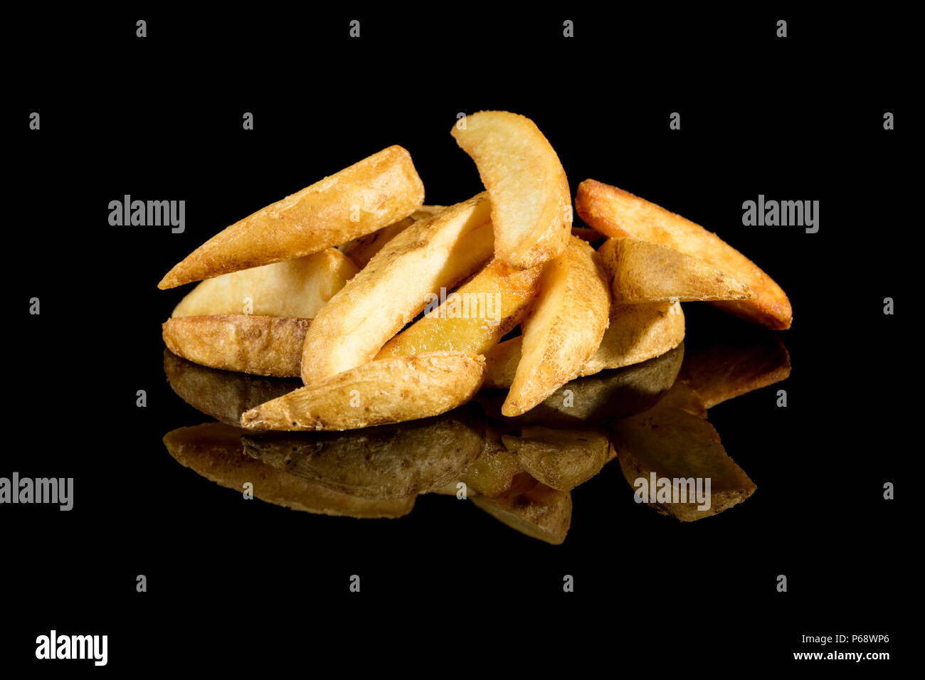 Pile of Wedges Fries with reflection isolated on black background Stock ...