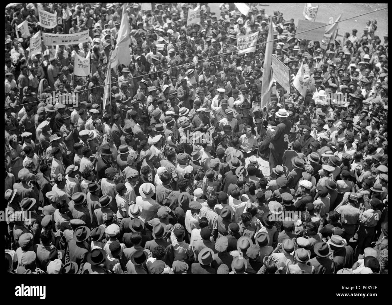 Photograph of crowds outside the Rehavia gymnasium listening to a ...
