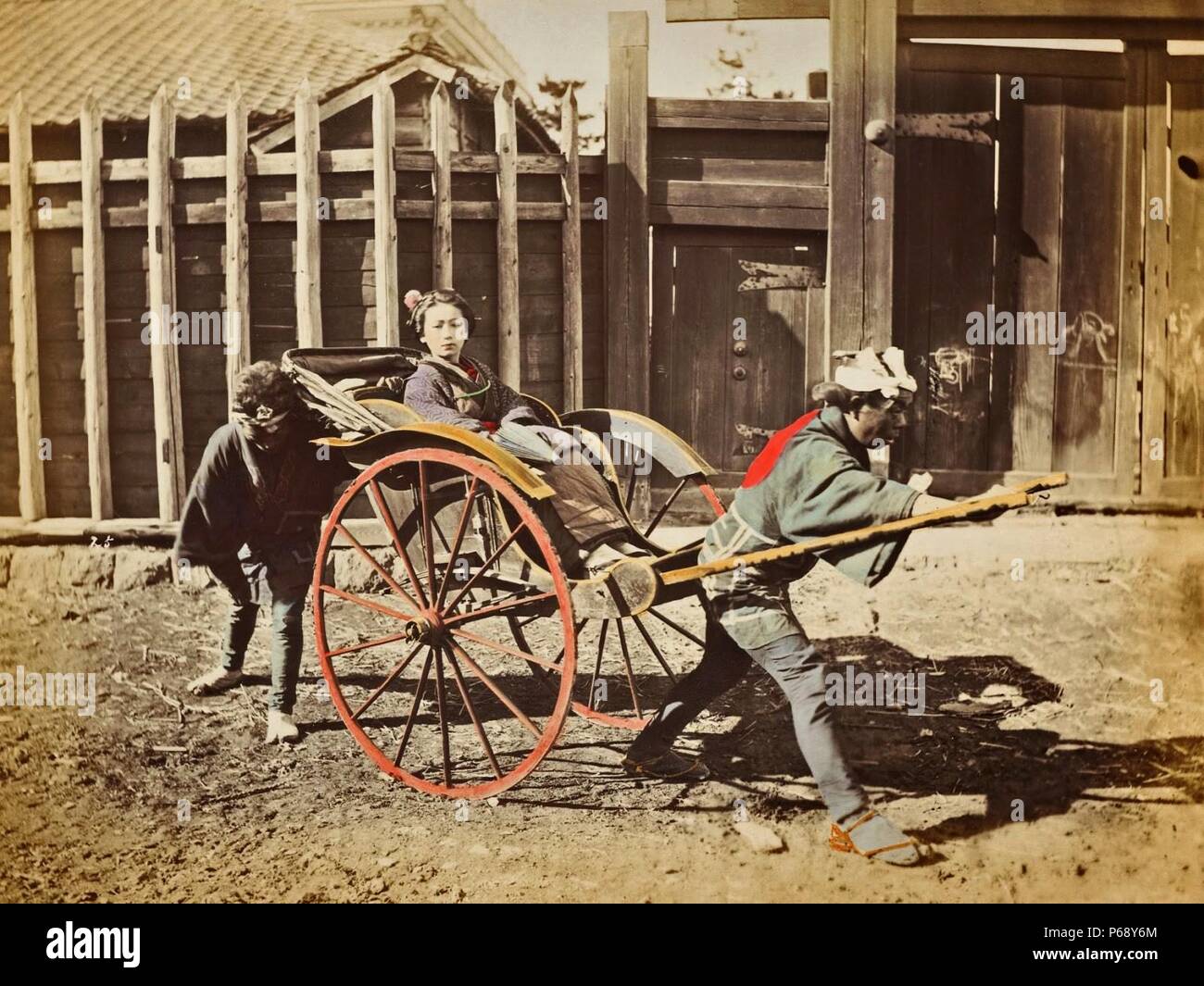 Colour photograph of Japanese women in a rickshaw, with two drivers ...