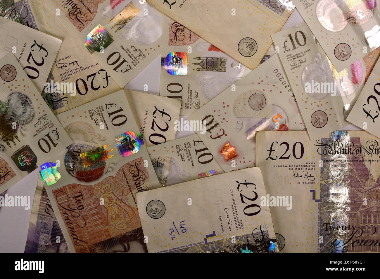 A large number of UK currency twenty and ten pound banknotes as a ...