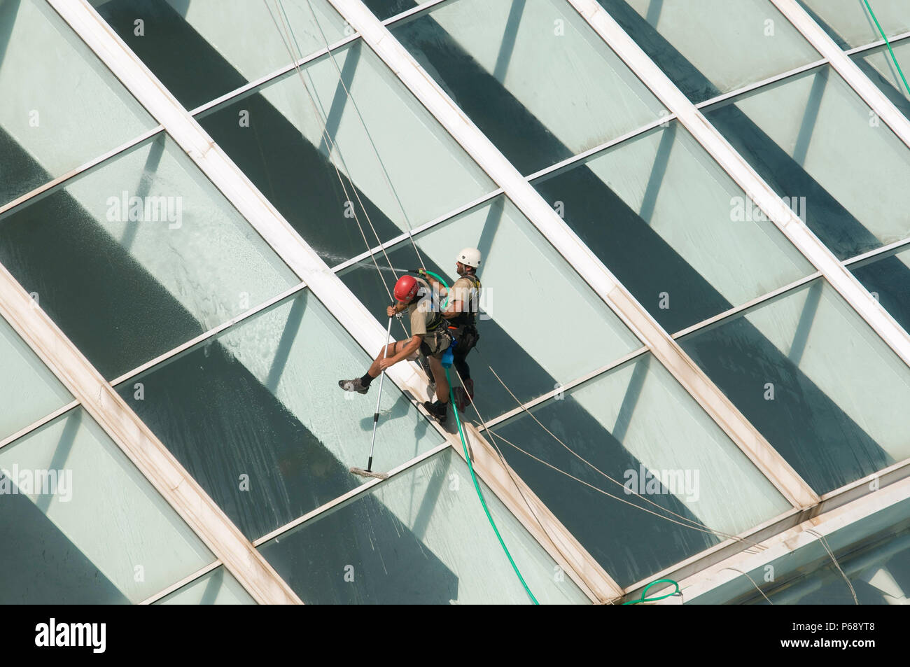 Workers cleaning glass building facade hi-res stock photography and ...
