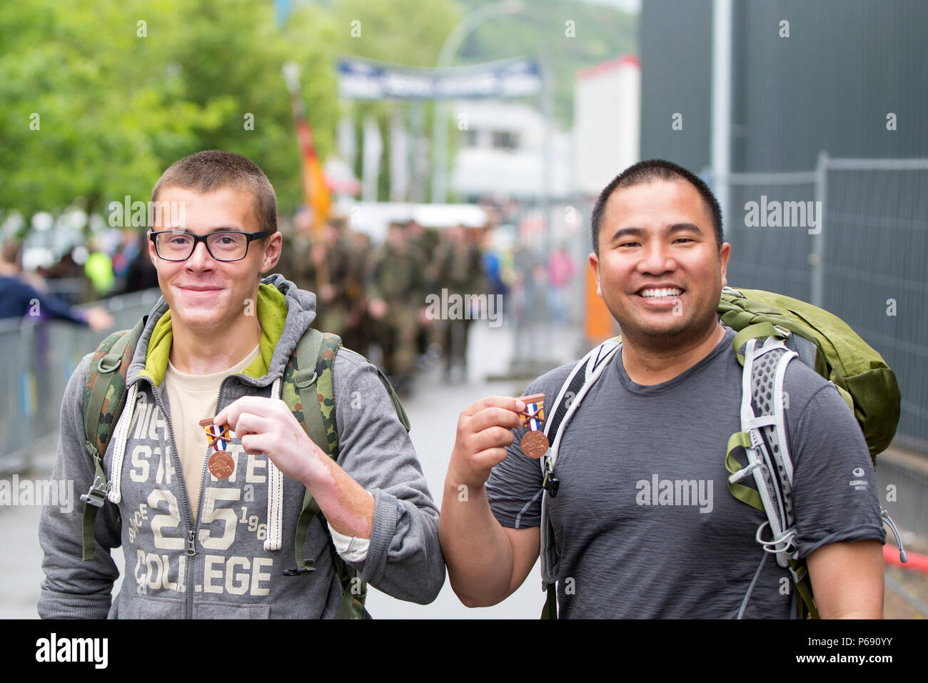 Participants pose for a photo with their medals after completing the ...