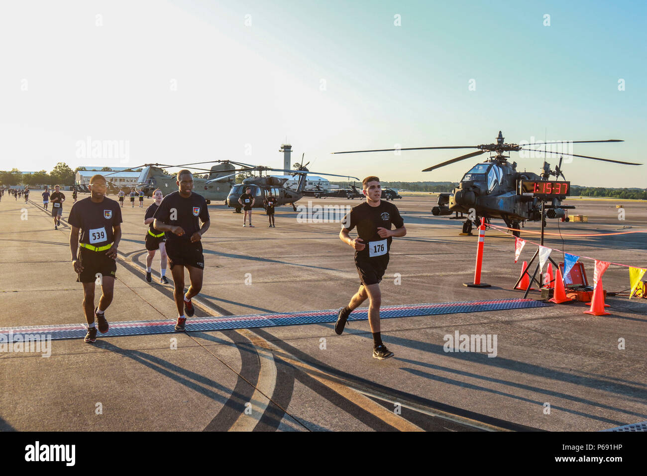 Runners in the 82nd Airborne Division 10-miler cross the finish line on ...