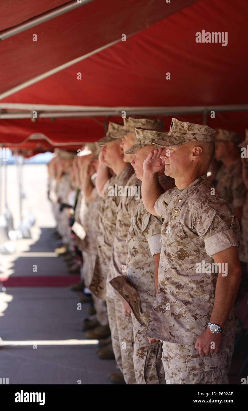 Marines salute the colors during a post and relief ceremony aboard ...