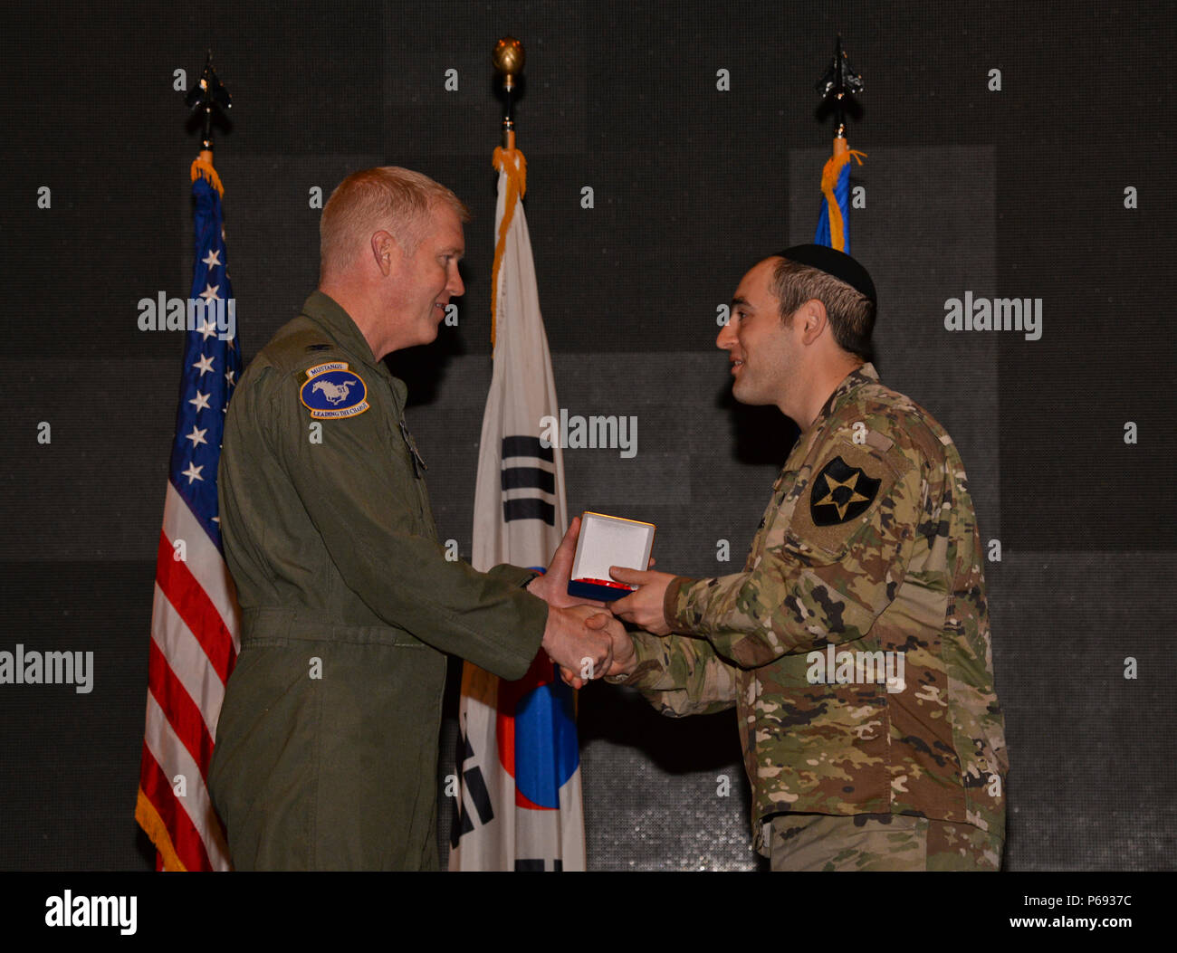 Col. Brian Carr, 51st Fighter Wing Commander, hands a gift to Army ...