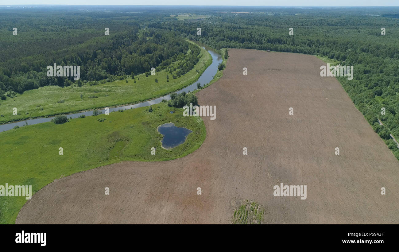 Aerial view summer landscape, river among trees, farmlands. Countryside ...