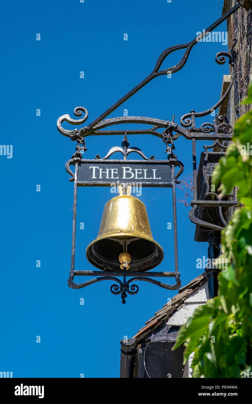 Brass bell pub sign Stock Photo - Alamy
