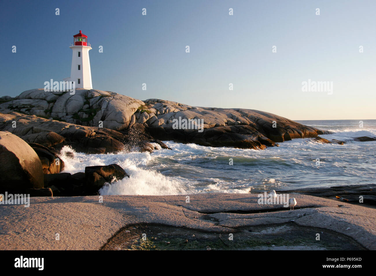 The iconic lighthouse set against the Atlantic Ocean with surf pounding ...