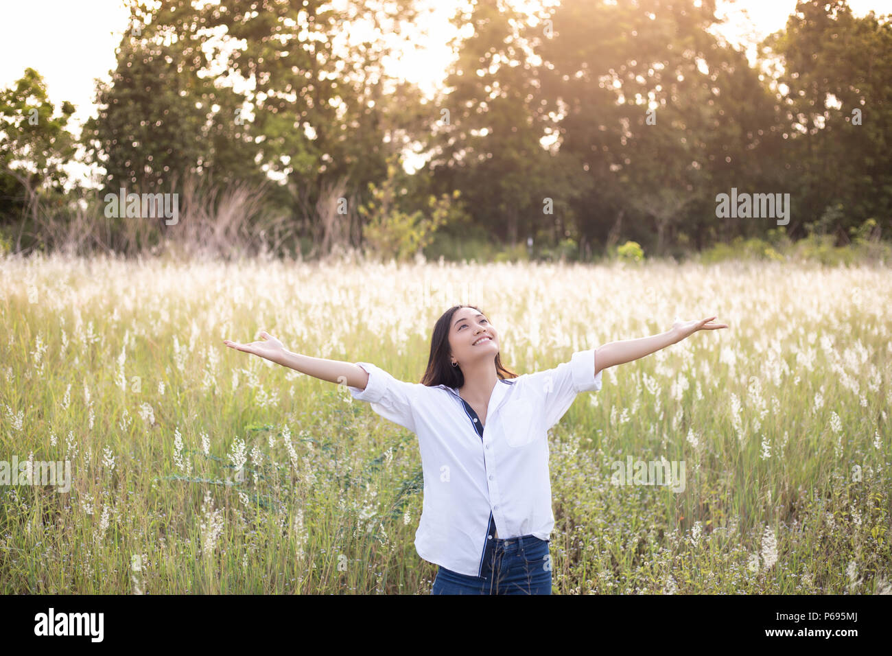 Asian women happy smile on relaxing time at the meadow and grass Stock ...
