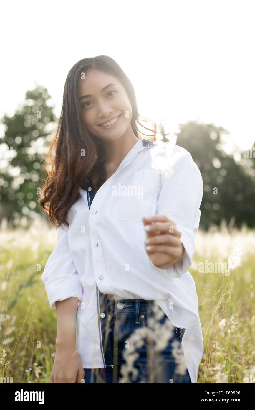 Asian women happy smile on relaxing time at the meadow and grass Stock ...