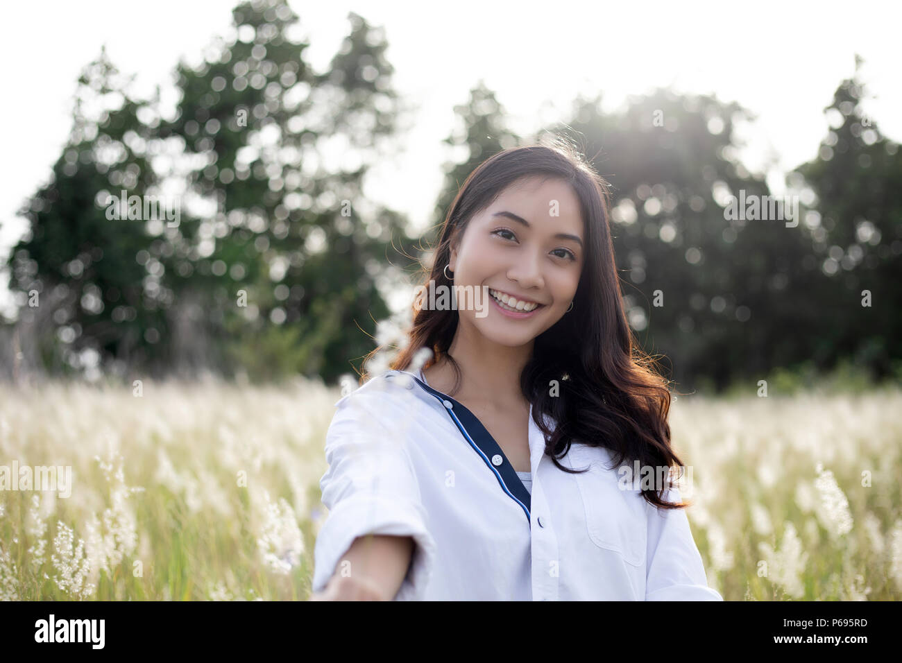 Asian women happy smile on relaxing time at the meadow and grass Stock ...