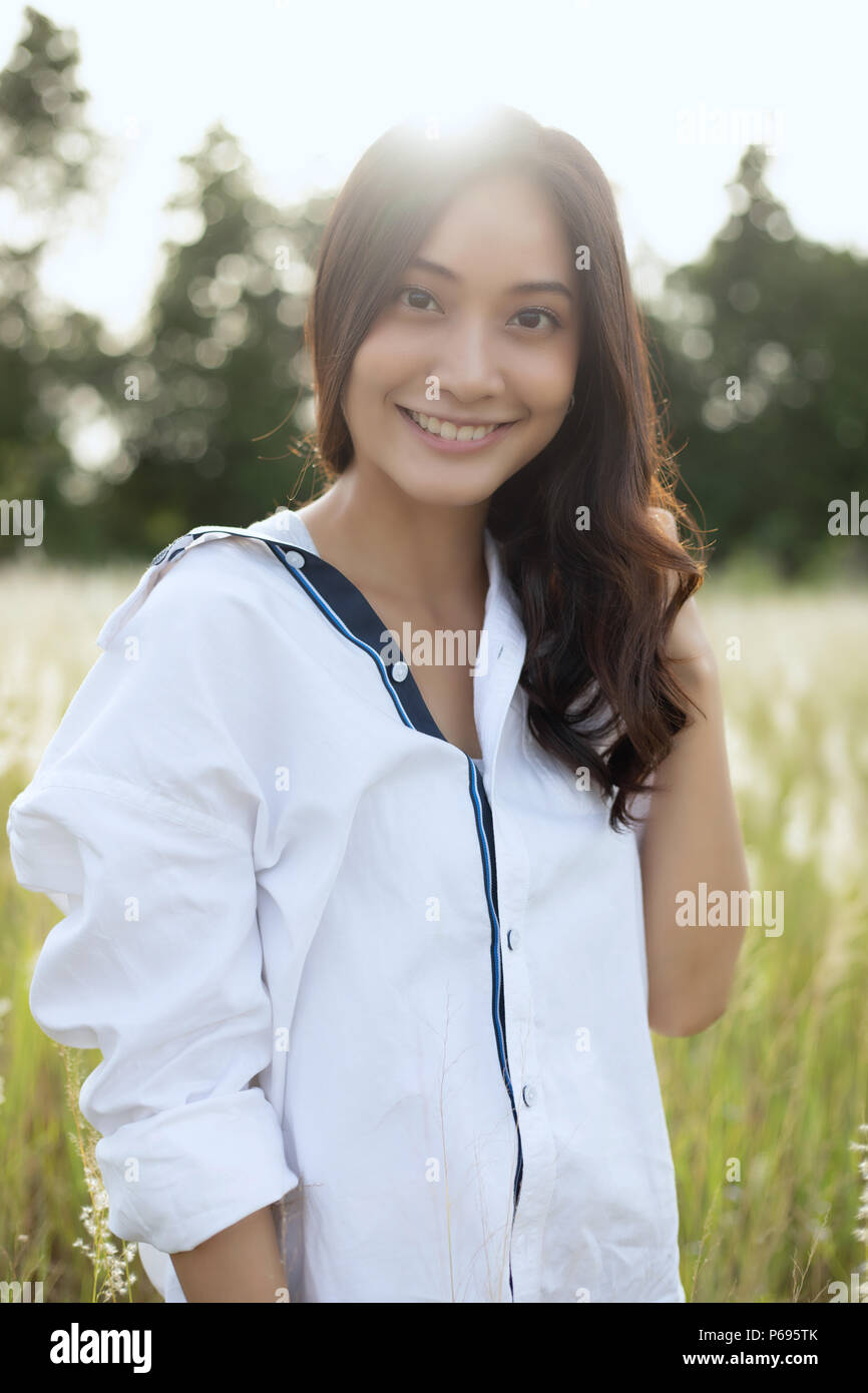 Asian women happy smile on relaxing time at the meadow and grass Stock ...