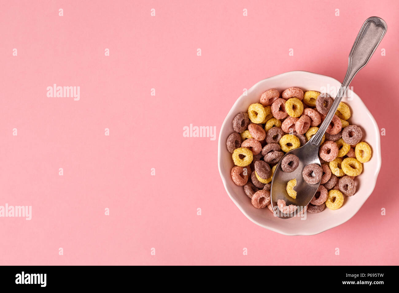 Healthy breakfast with colored grain rings and spoon with funny face ...