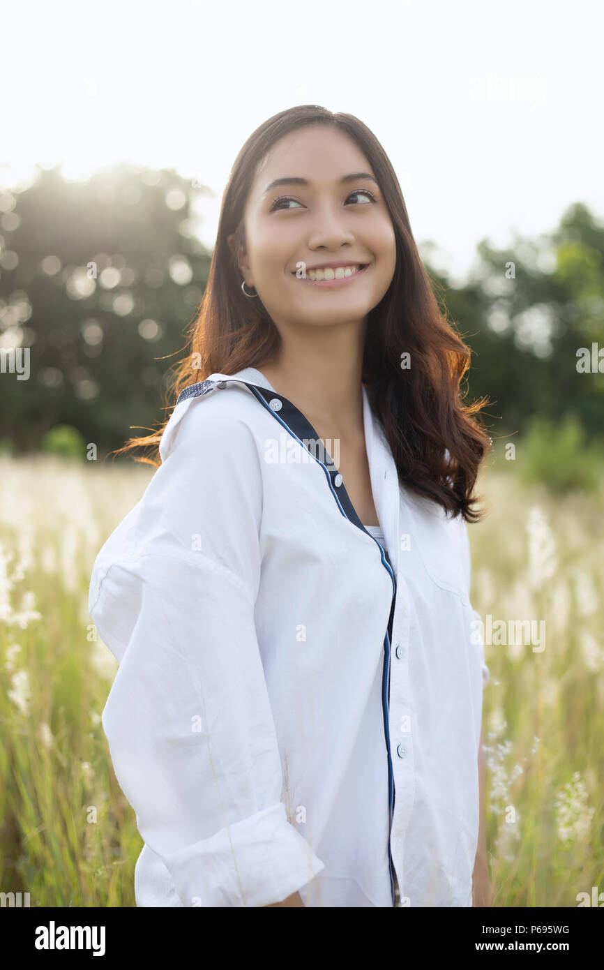 Asian women happy smile on relaxing time at the meadow and grass Stock ...