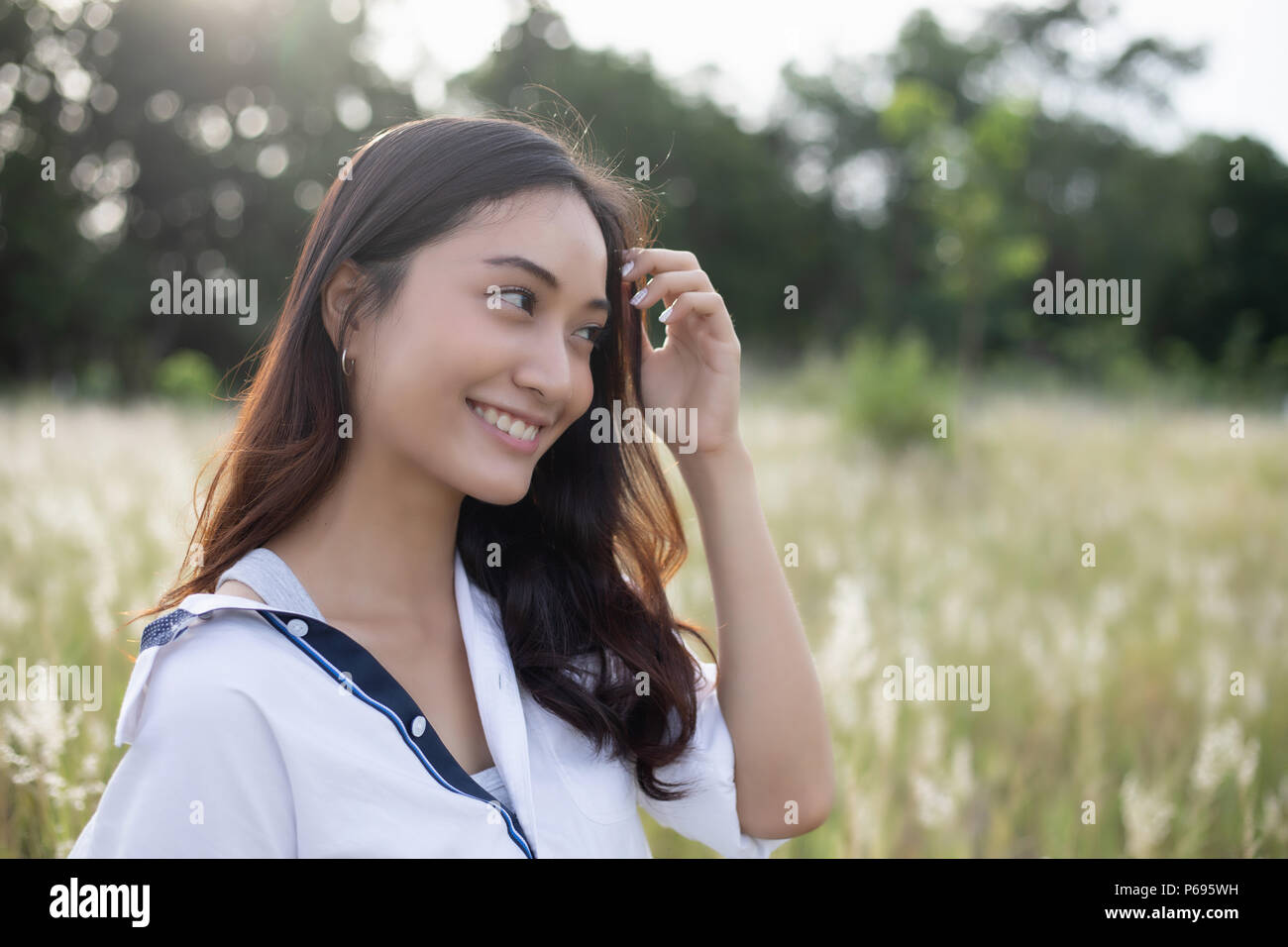 Asian women happy smile on relaxing time at the meadow and grass Stock ...