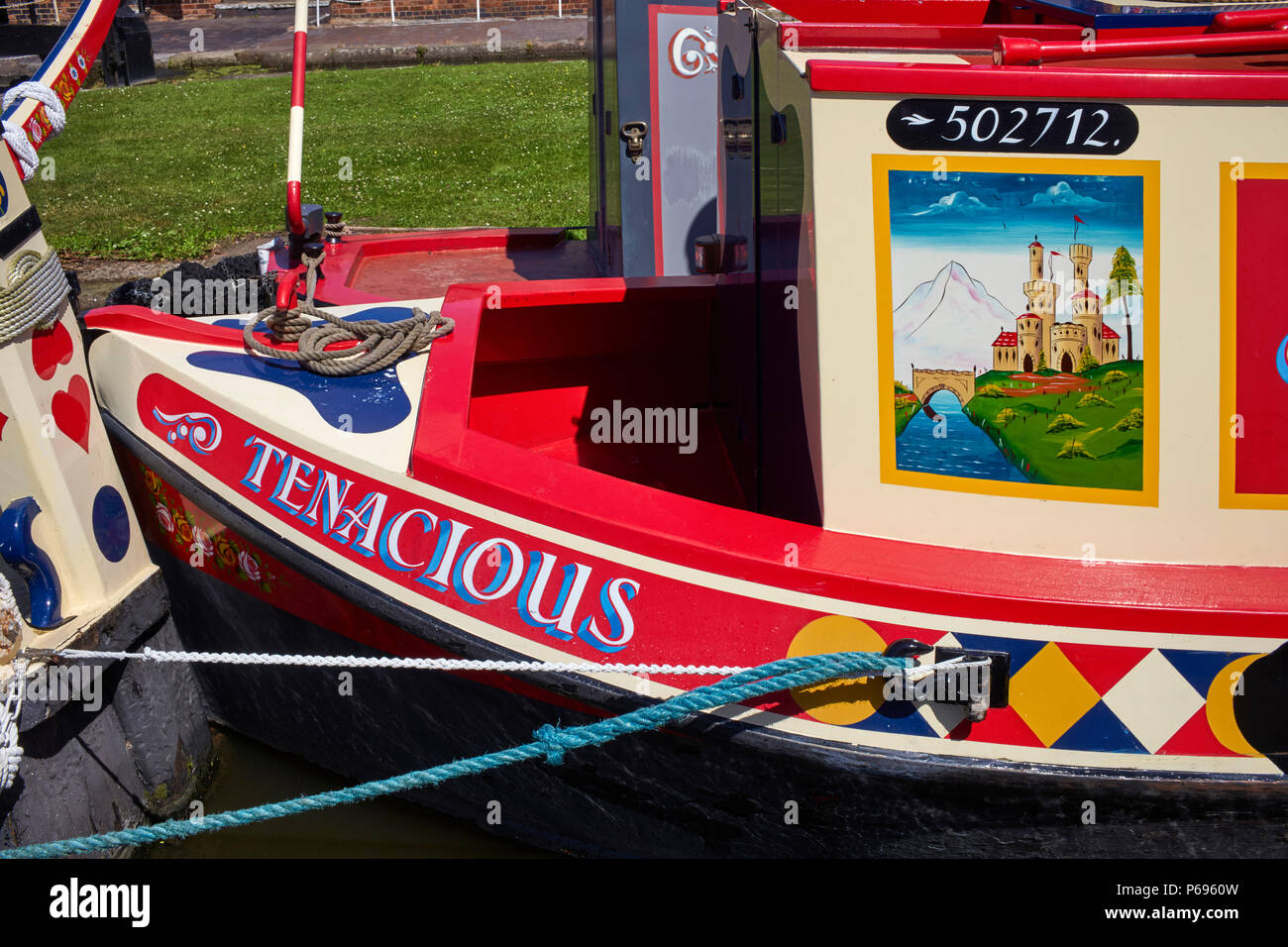 Highly decorated narrowboat Tenacious showing castles image and bright ...