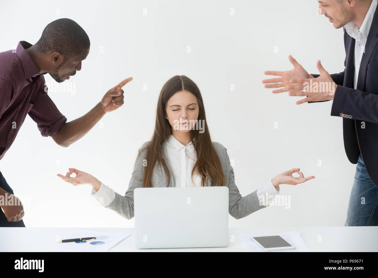 Calm female employee practicing yoga at workplace Stock Photo - Alamy