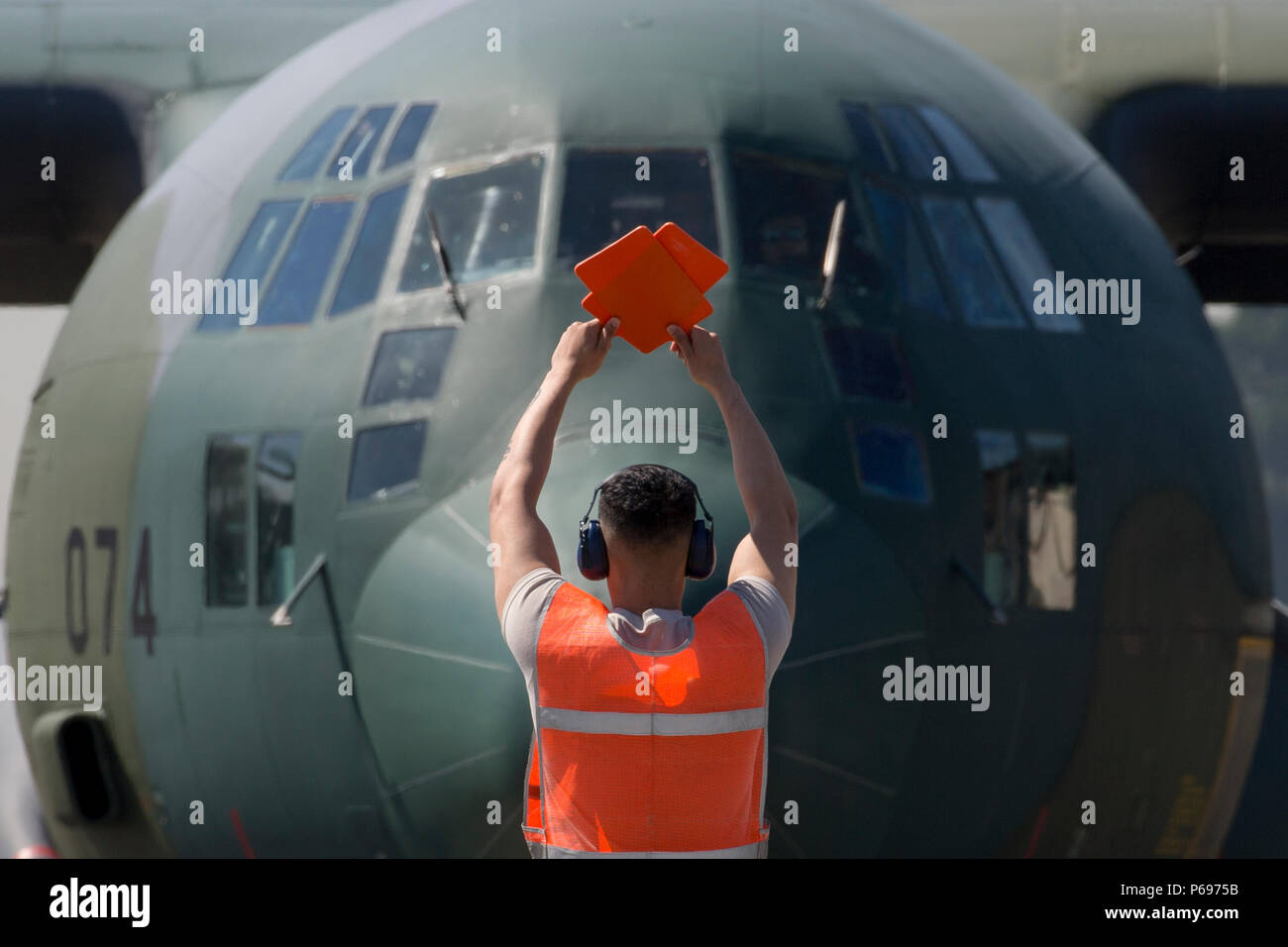 A crew chief with the 374th Aircraft Maintenance Squadron marshals a ...