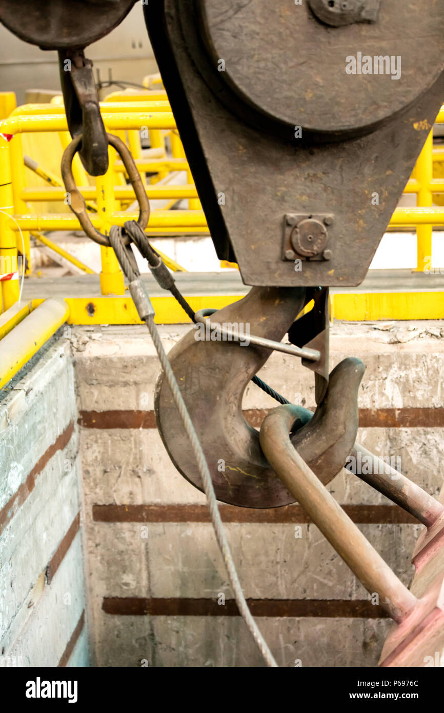 large iron hook used to lift heavy loads in a workshop with safety ...