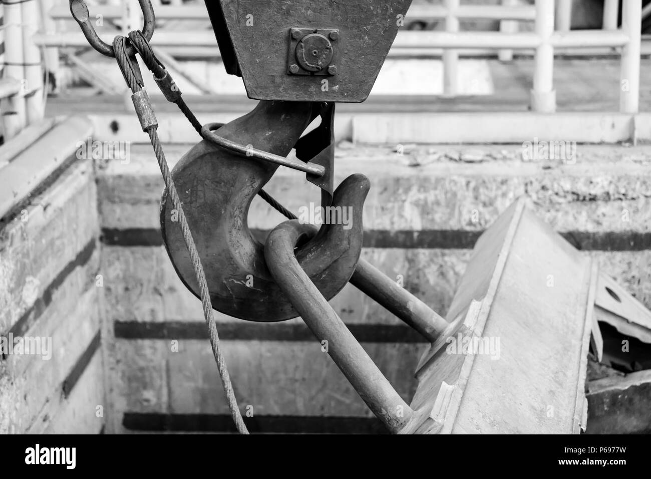 large iron hook used to lift heavy loads in a workshop with safety ...