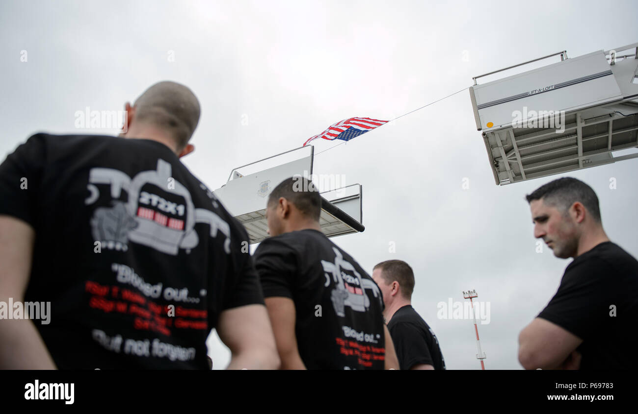 Airmen from the 721st Aerial Port Squadron listen to a memorial at ...