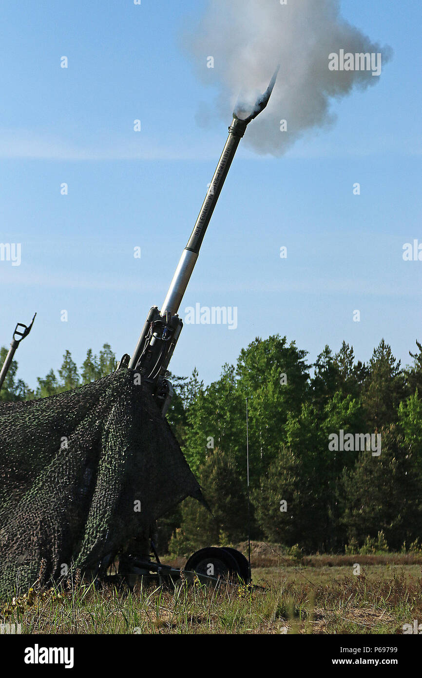 An M777 A2 towed Howitzer fires as soldiers assigned to B Battery ...