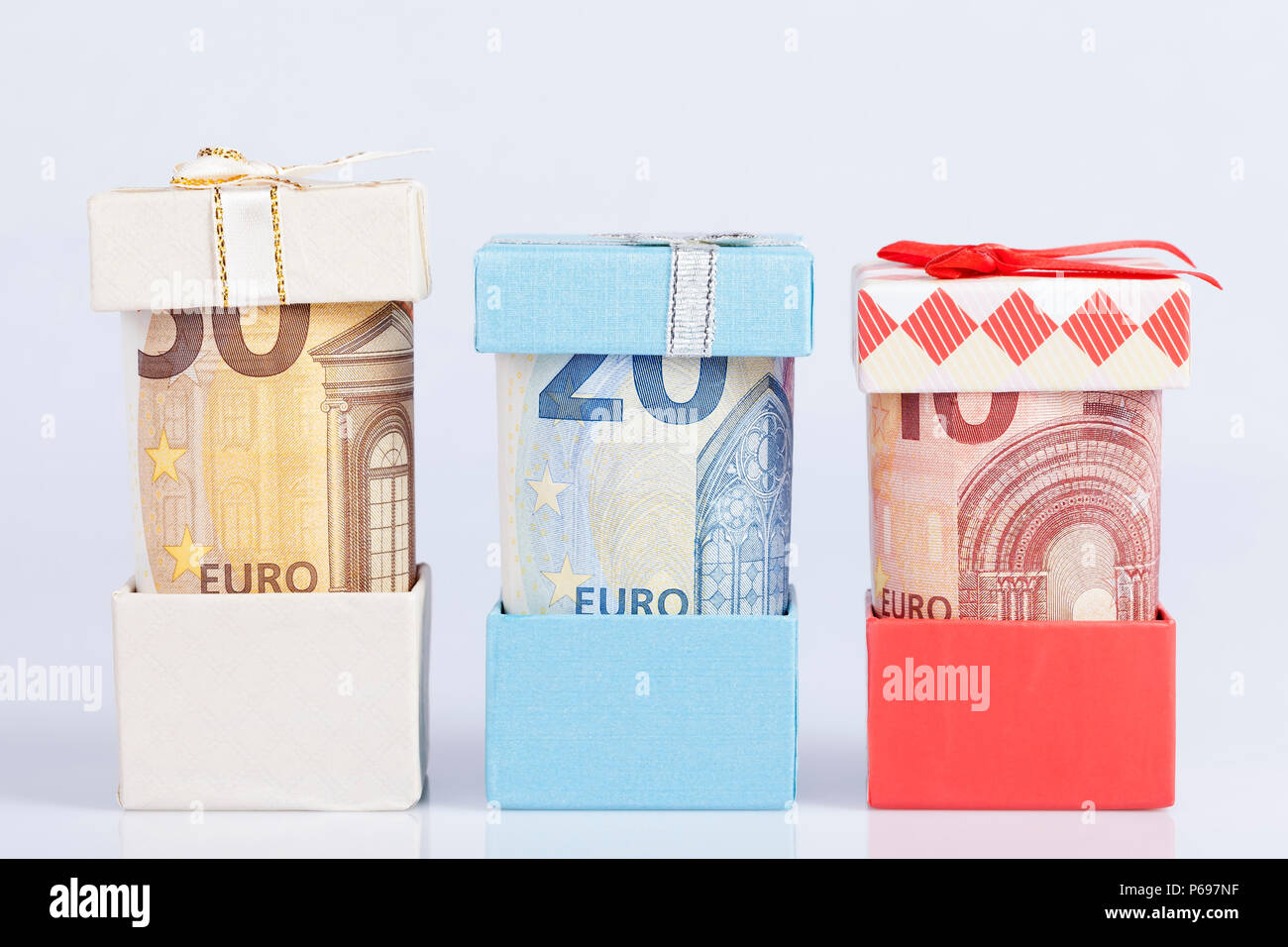 Various euro bills inside gift boxes and isolated on white background ...