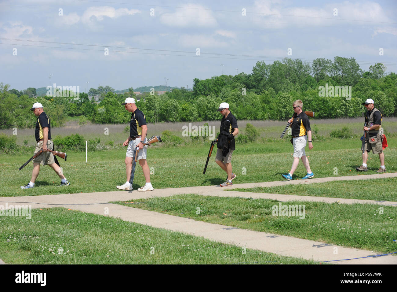 Members of the Army Skeet team walk to the next shooting position ...