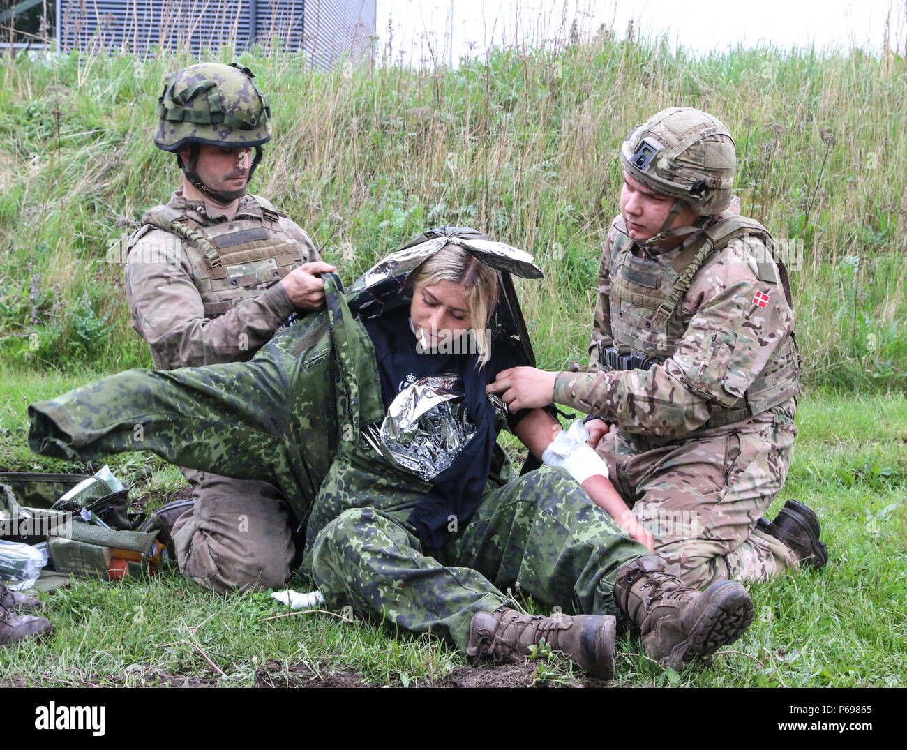 Royal Danish Army Soldiers treat a casualty during the Nordic Tank ...