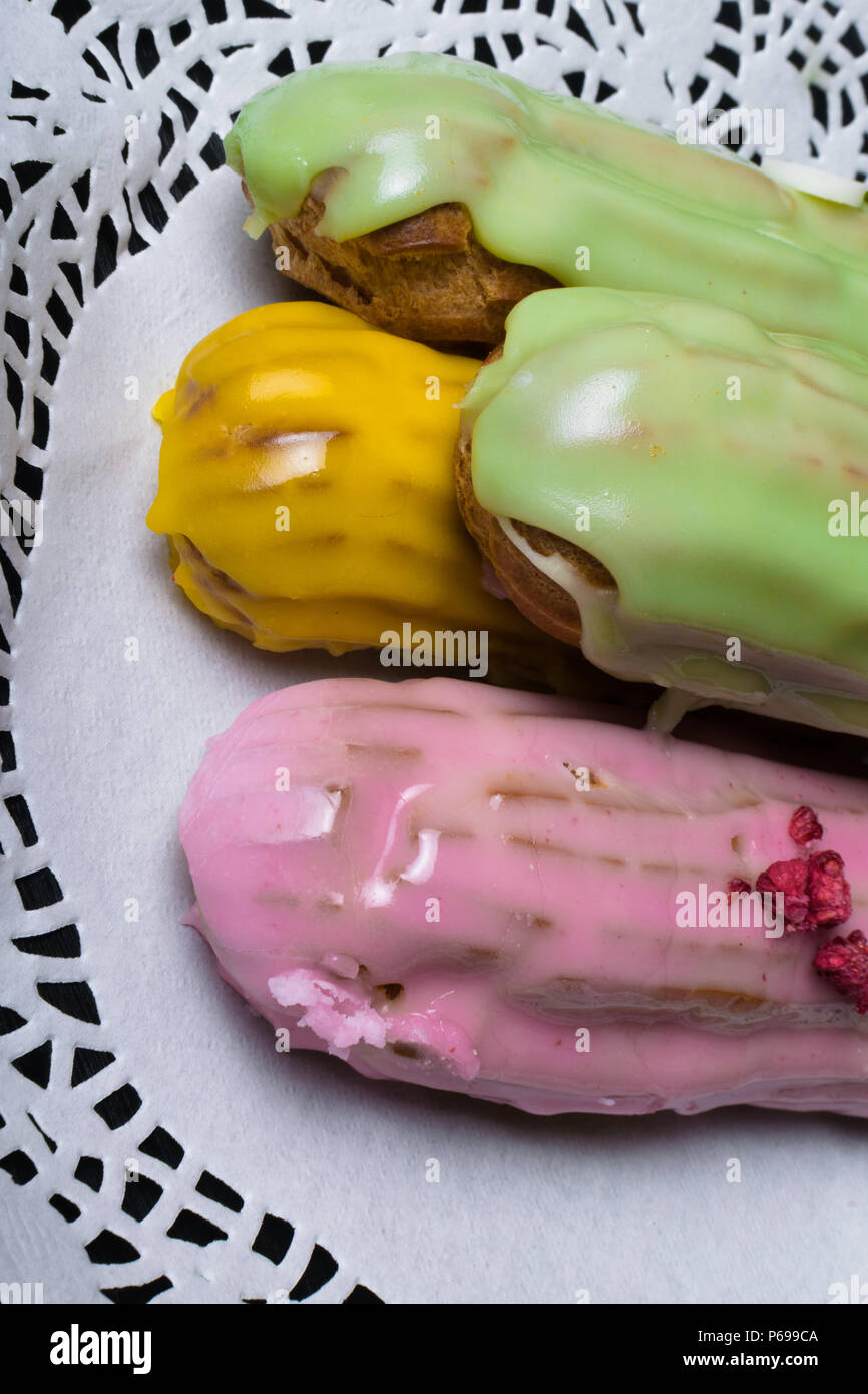 French traditional eclair, decorated with raspberry and cream on the ...