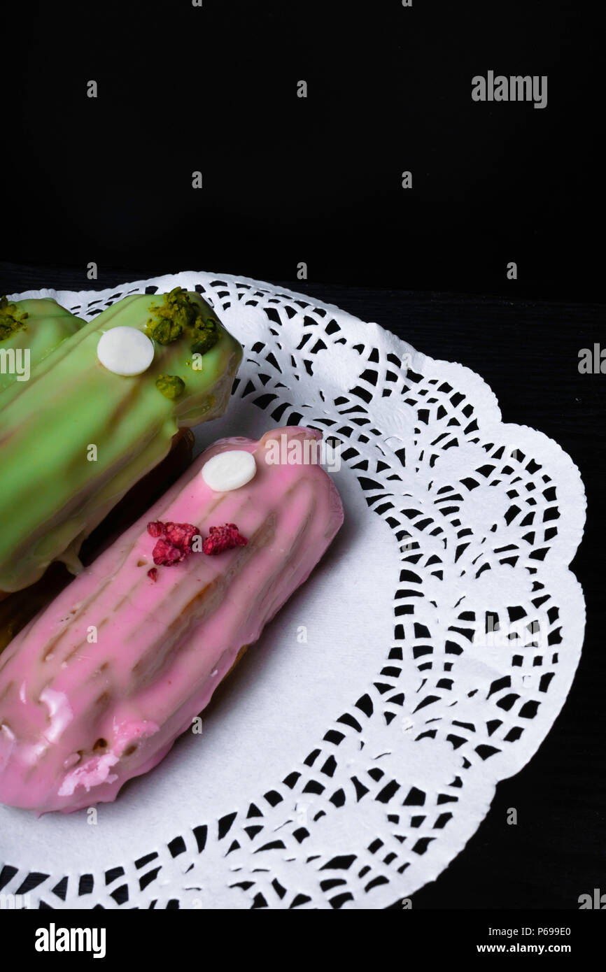 French traditional eclair, decorated with raspberry and cream on the ...