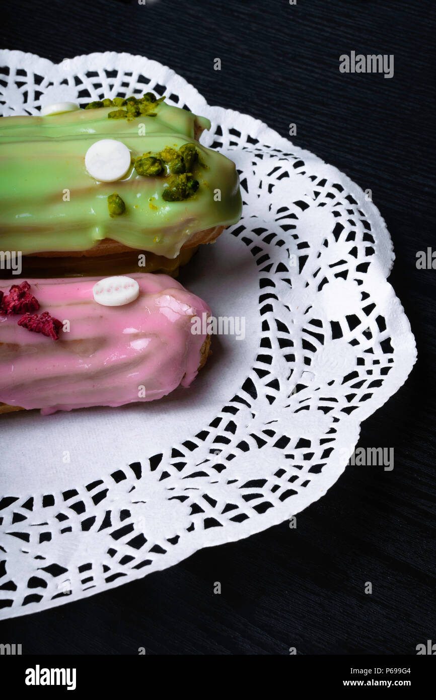 French traditional eclair, decorated with raspberry and cream on the ...