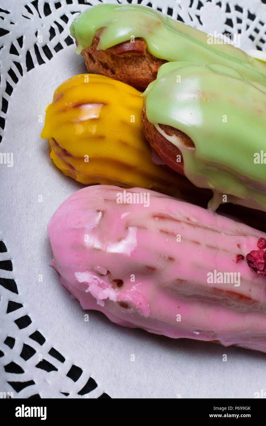 French traditional eclair, decorated with raspberry and cream on the ...