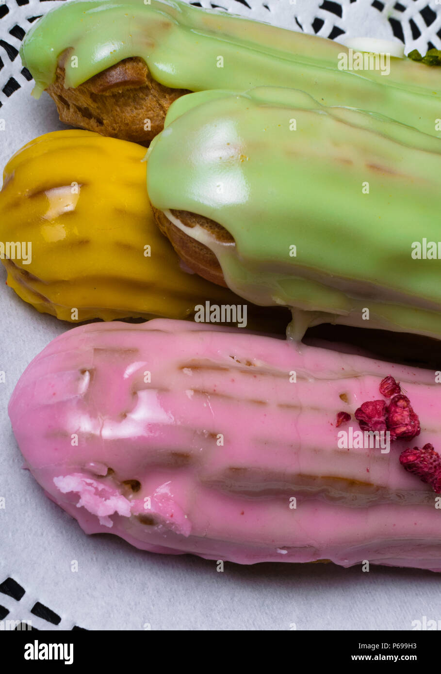 French traditional eclair, decorated with raspberry and cream on the ...