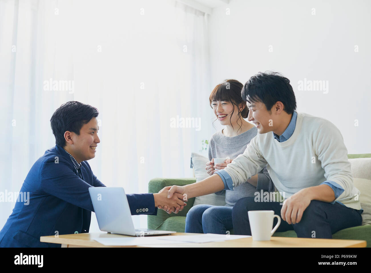 Japanese couple talking with salesman Stock Photo - Alamy