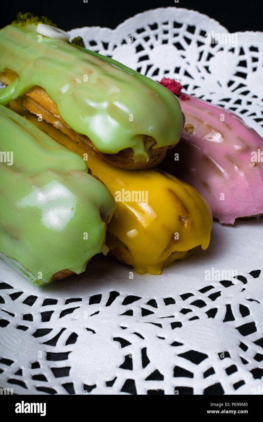 French traditional eclair, decorated with raspberry and cream on the ...