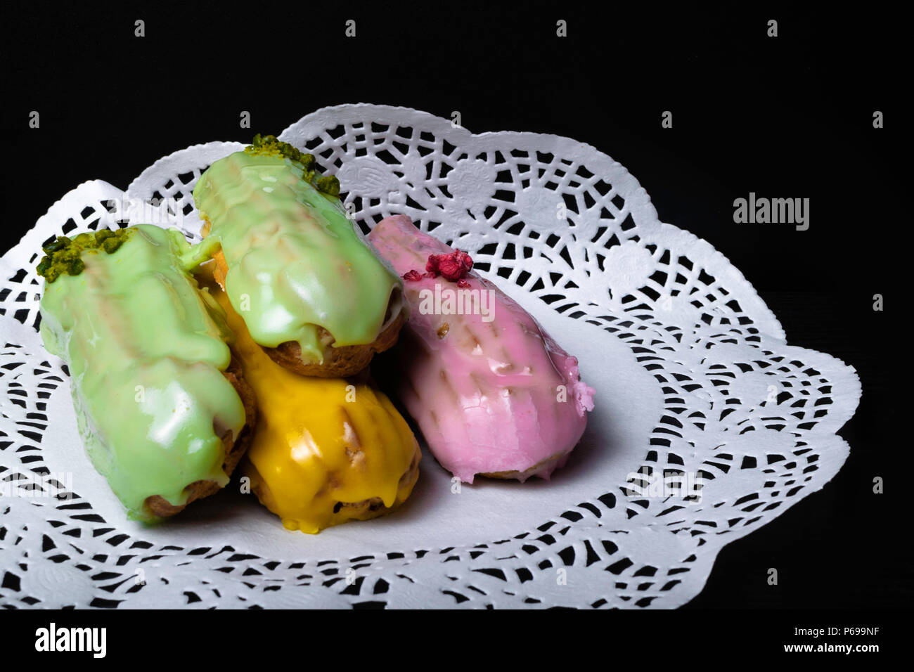French traditional eclair, decorated with raspberry and cream on the ...