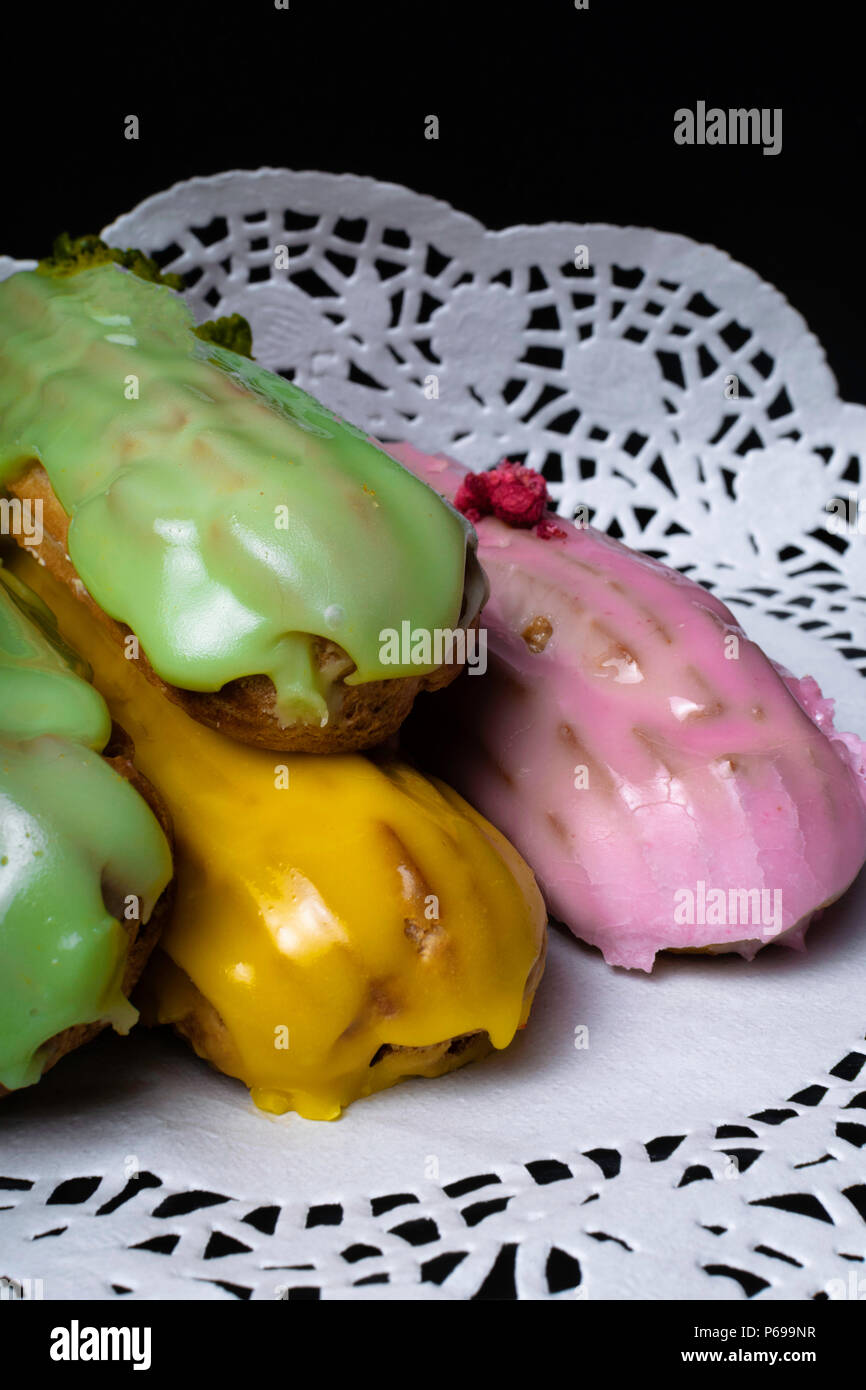 French traditional eclair, decorated with raspberry and cream on the ...