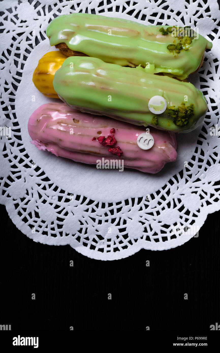 French traditional eclair, decorated with raspberry and cream on the ...
