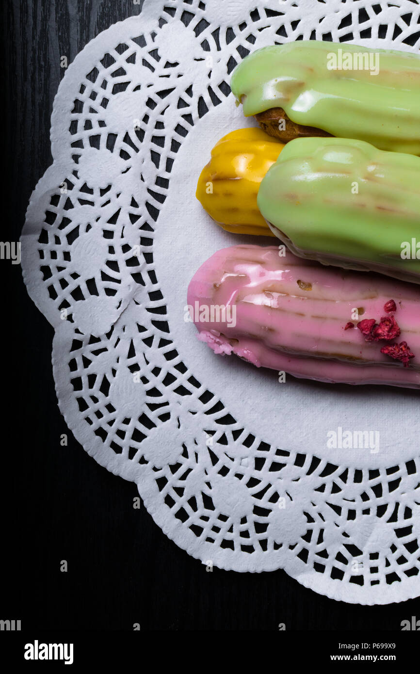 French traditional eclair, decorated with raspberry and cream on the ...