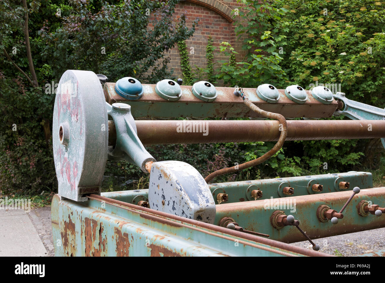 A vintage, rusty 6 head wood copy pantograph machine, abandoned outside ...