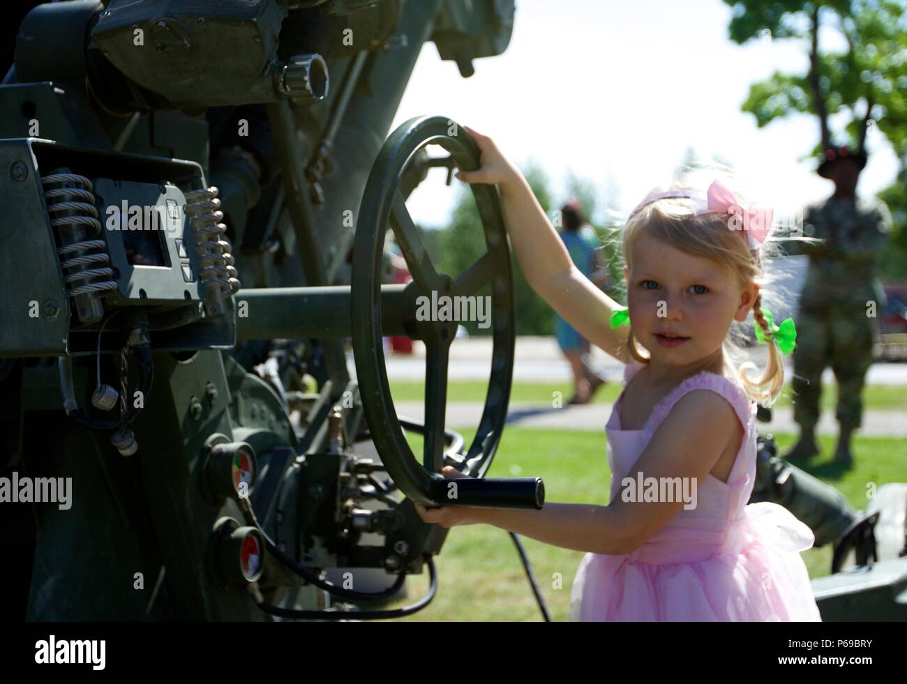 A Latvian girl turns the elevation hand wheel on a M777 A2 Howitzer ...