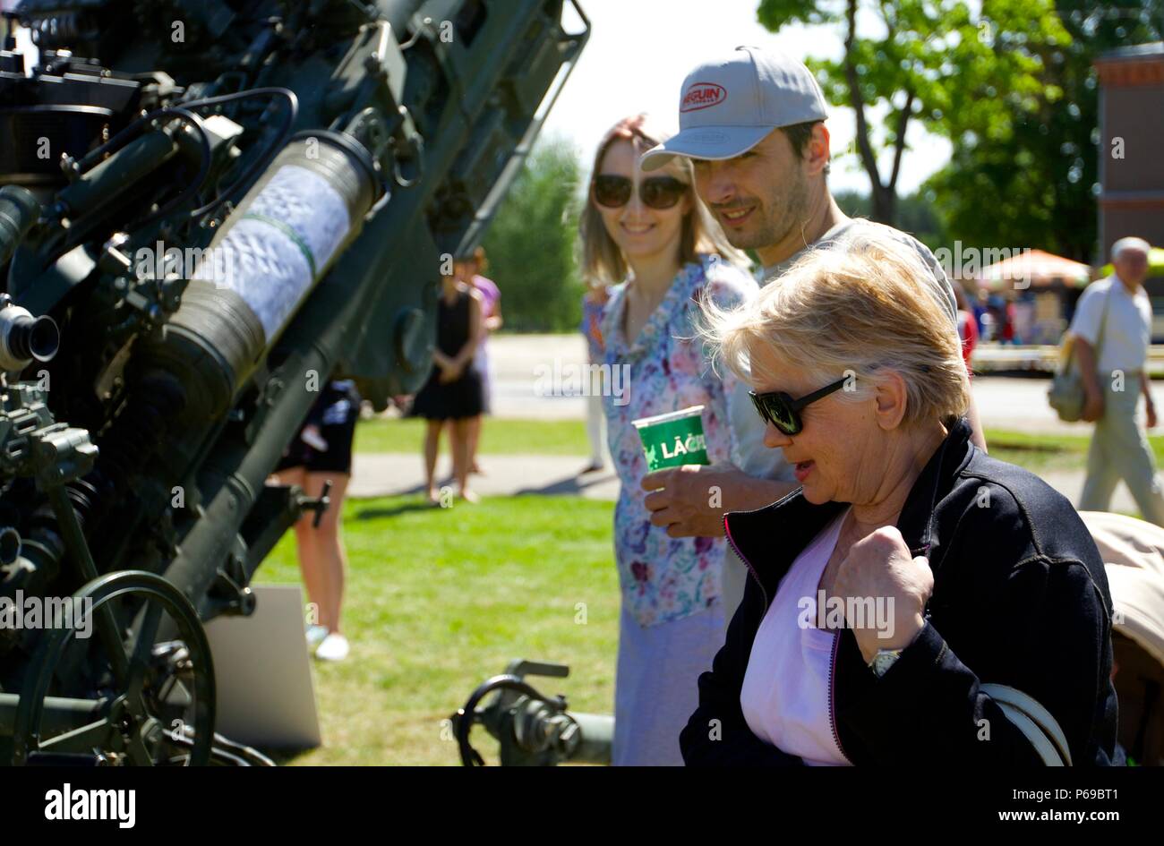 A Latvian family looks at an M777 A2 Howitzer during the Gauja ...