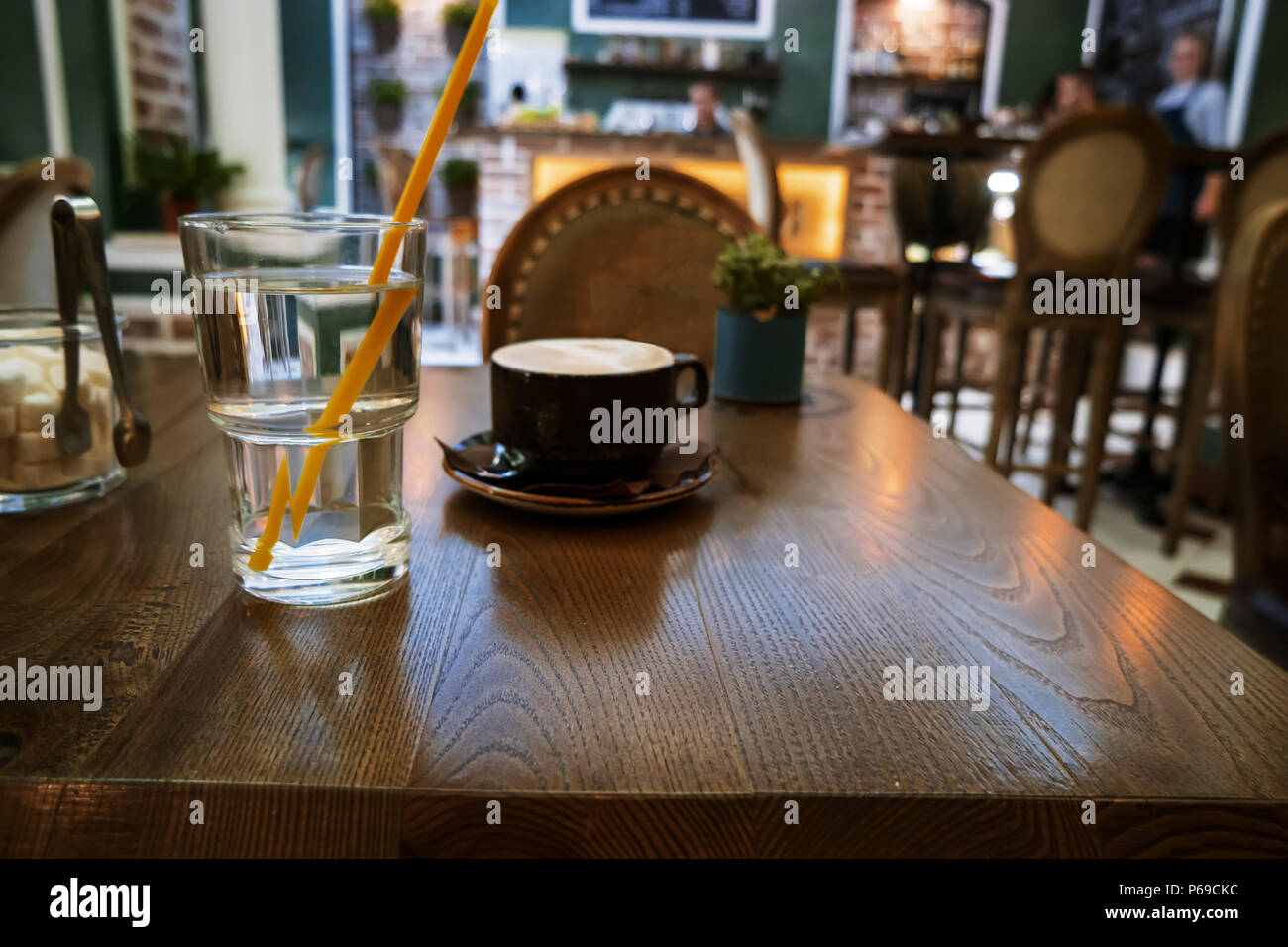 Coffee Cup on table in Cafe, Interior blurred Stock Photo - Alamy