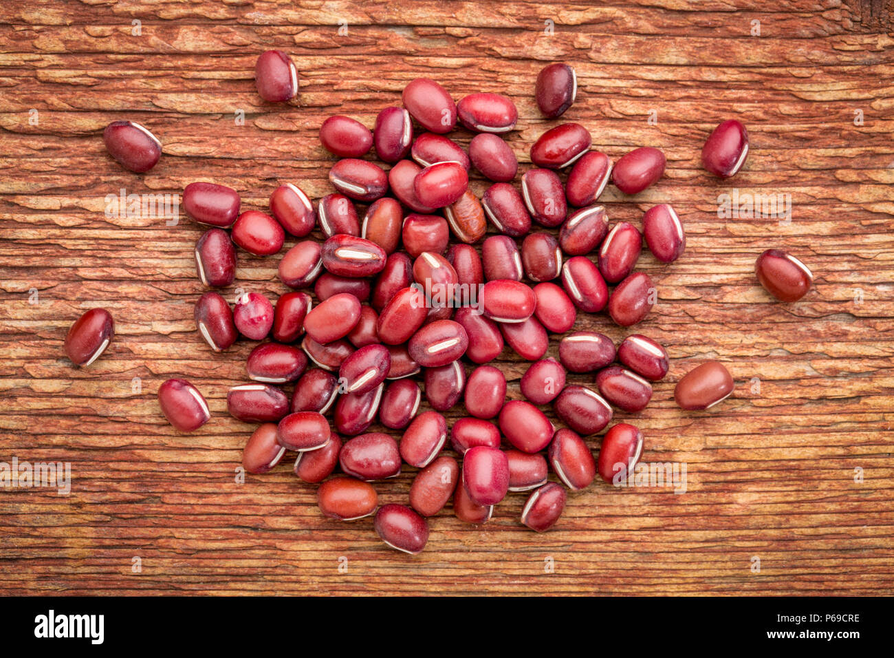 a small pile of Japanese adzuki (aduki, azuki) beans on a rustic barn ...
